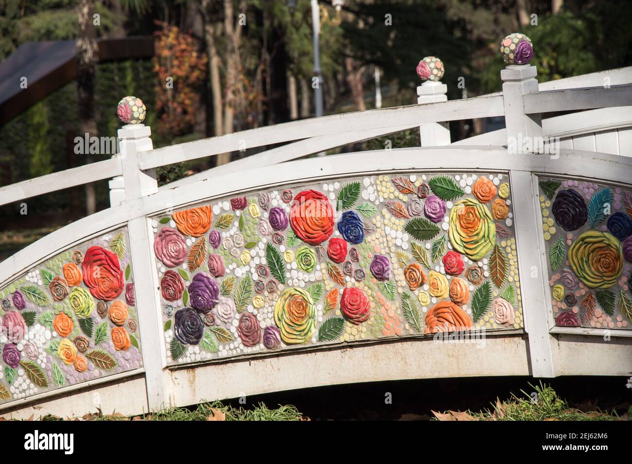Wooden white bridge with colorful flowers ornated on it on display ...