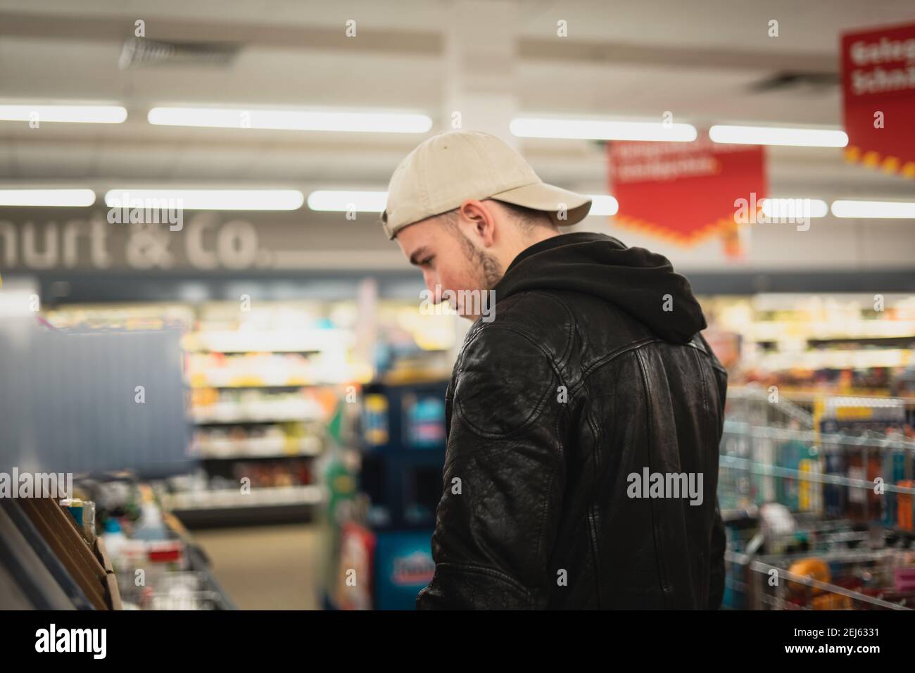 A young guy shopping in the supermarket Stock Photo - Alamy