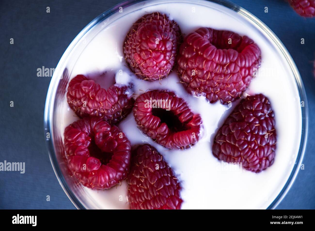 Glass of yogurt and raspberries zenith Stock Photo - Alamy