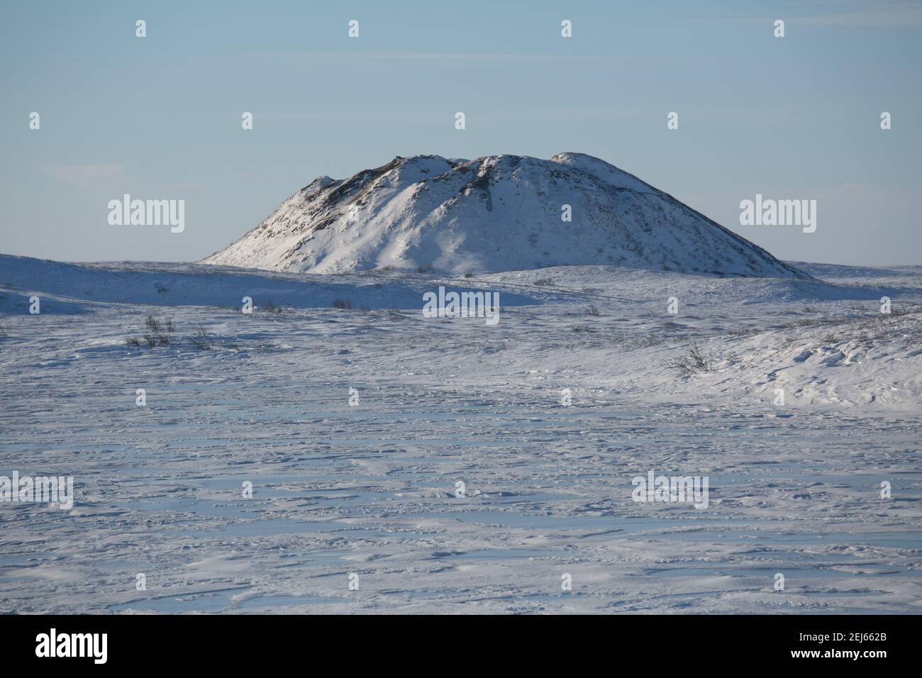 A pingo landmark (intra-permafrost ice-cored hill) in winter on the ...