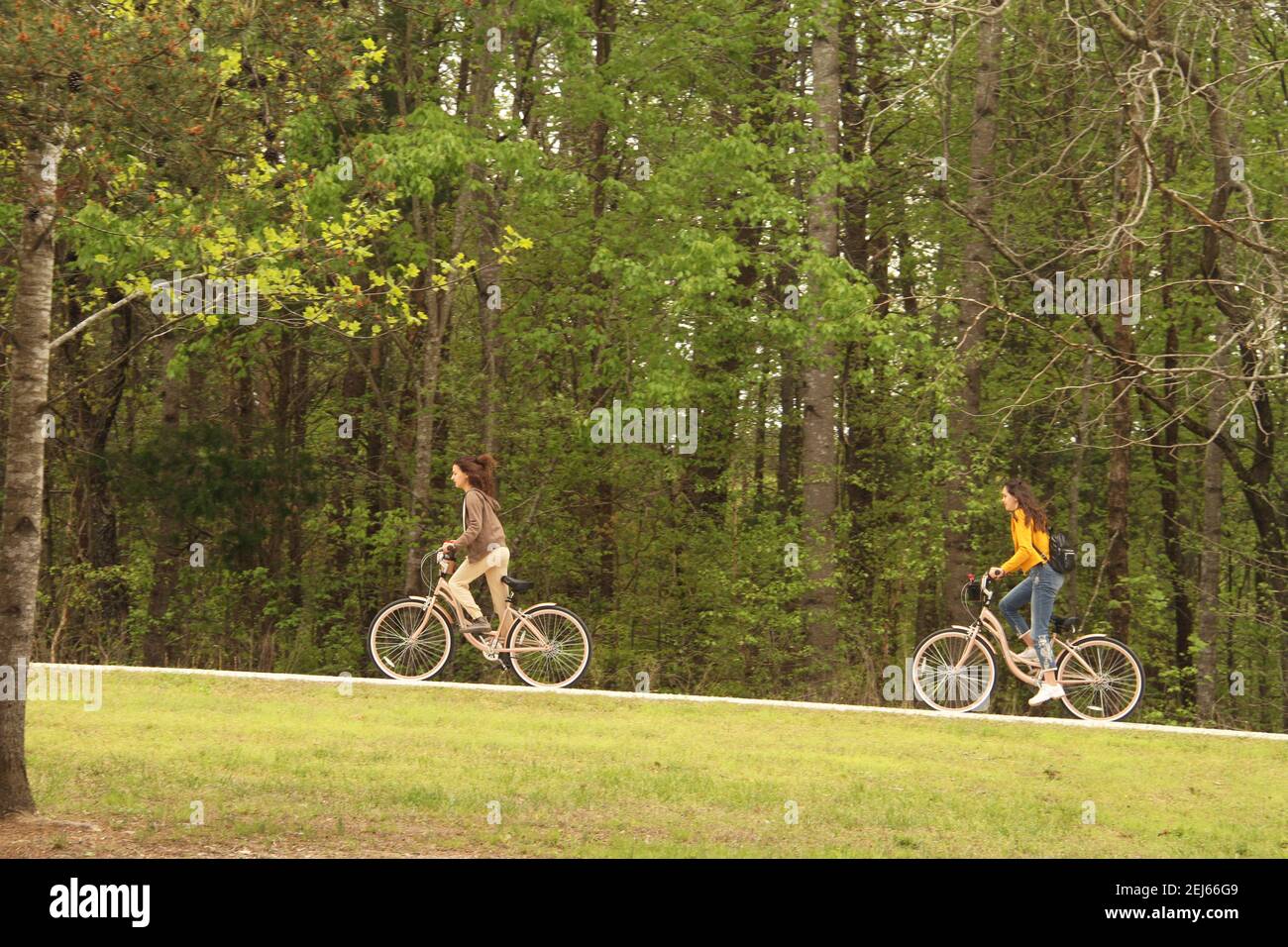 Young girls riding their bicycles on a trail Stock Photo - Alamy