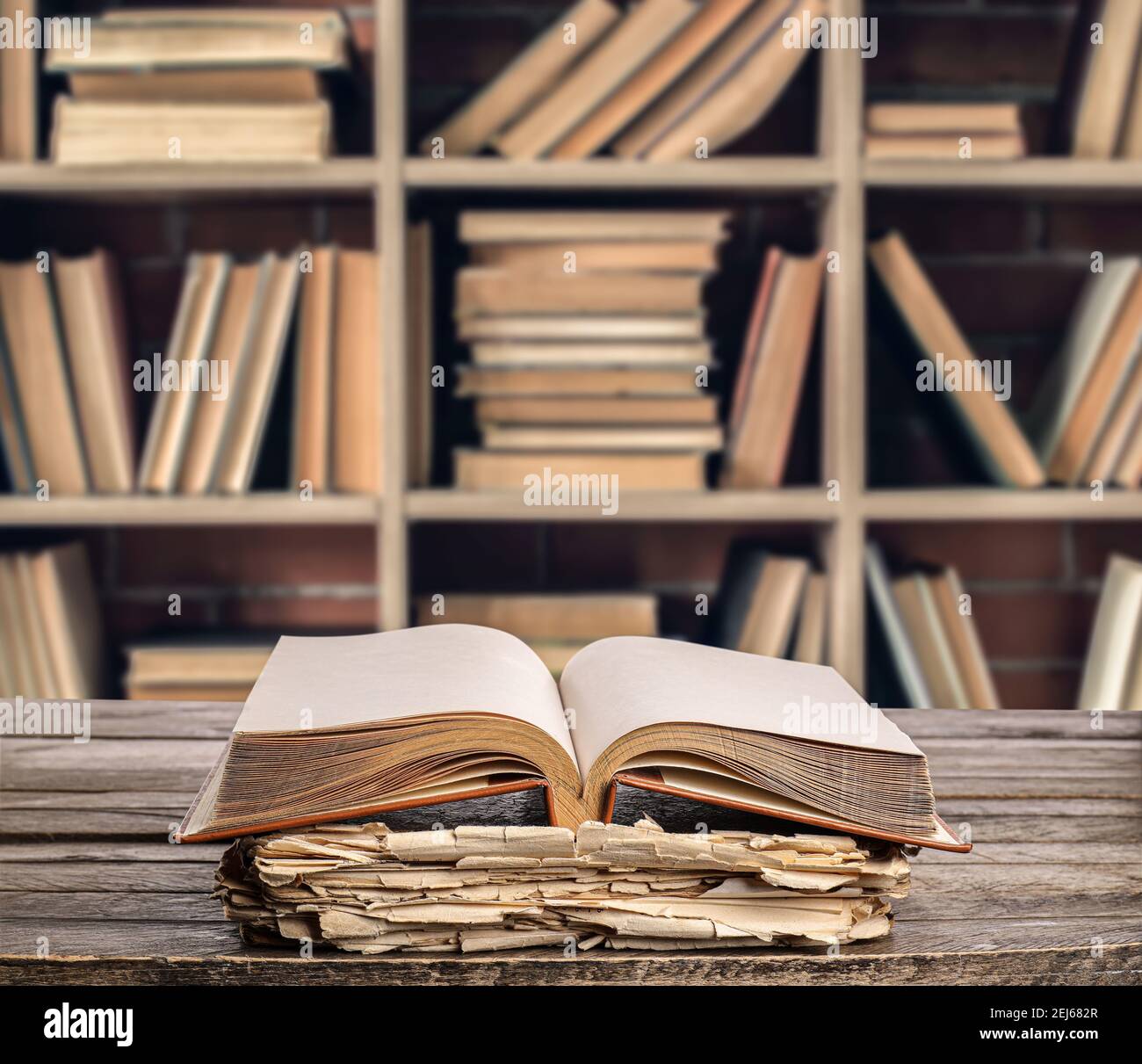 Old books on table in library Stock Photo - Alamy