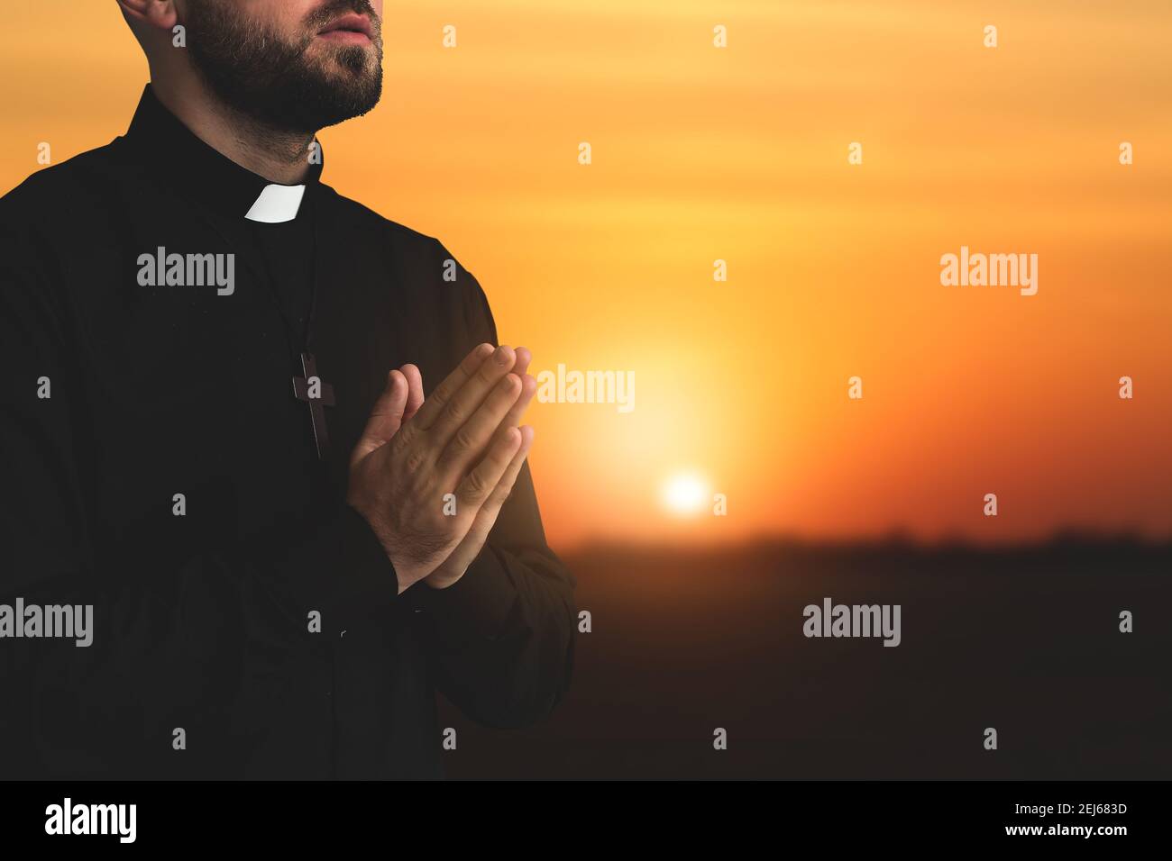 Young priest praying to God in morning Stock Photo - Alamy