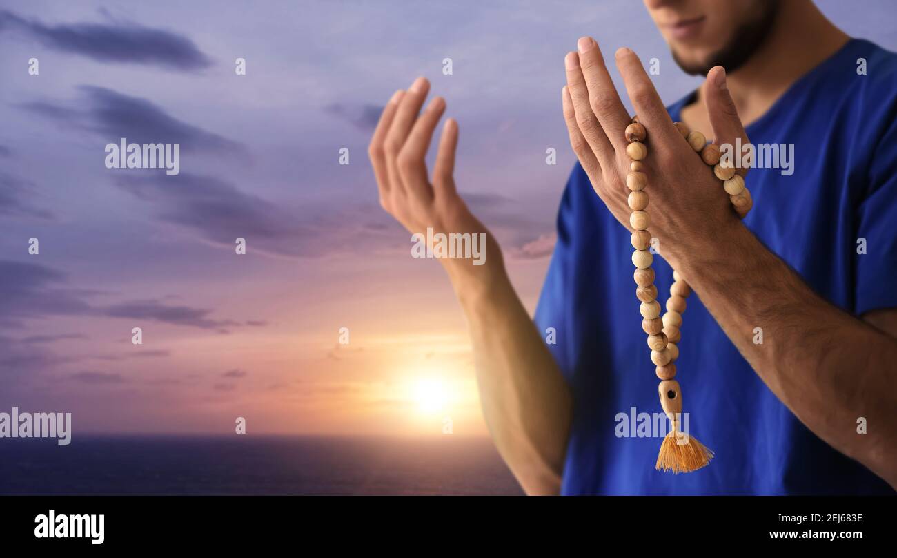 Young Muslim man praying at sunrise Stock Photo - Alamy