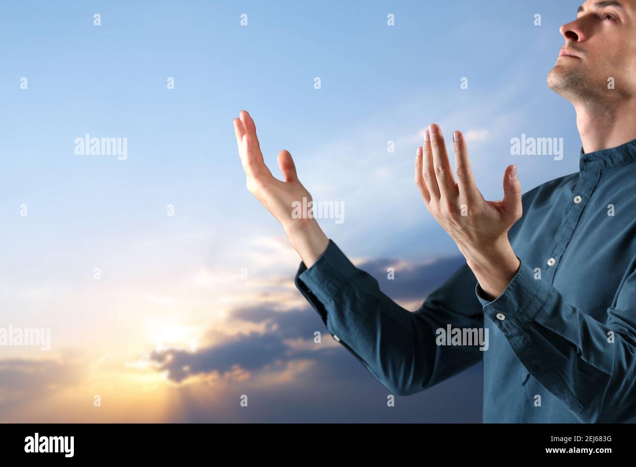 Religious man praying to God at sunrise Stock Photo - Alamy