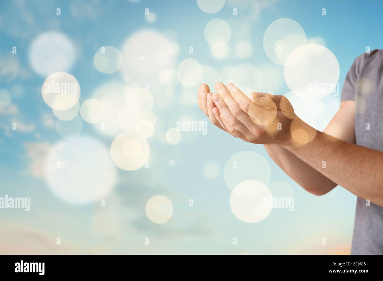 Religious young man praying to God on color background Stock Photo - Alamy