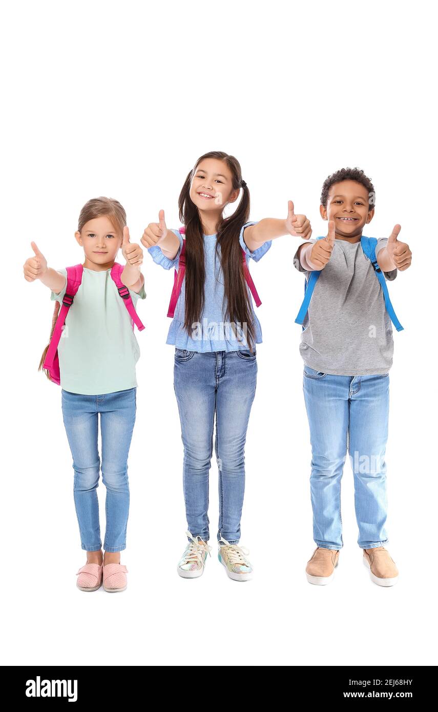Happy little schoolchildren showing thumb-up gesture on white ...