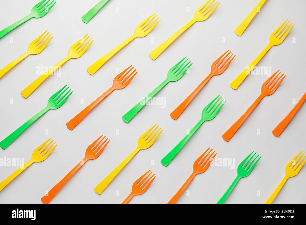 Plastic forks on light background Stock Photo - Alamy