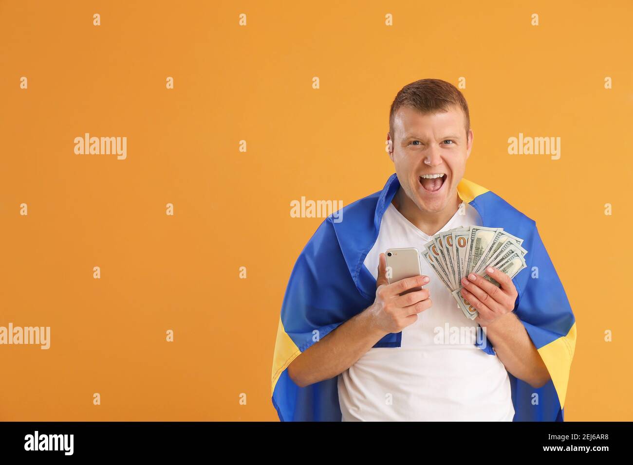 Happy man after winning of his sports bet on color background Stock ...