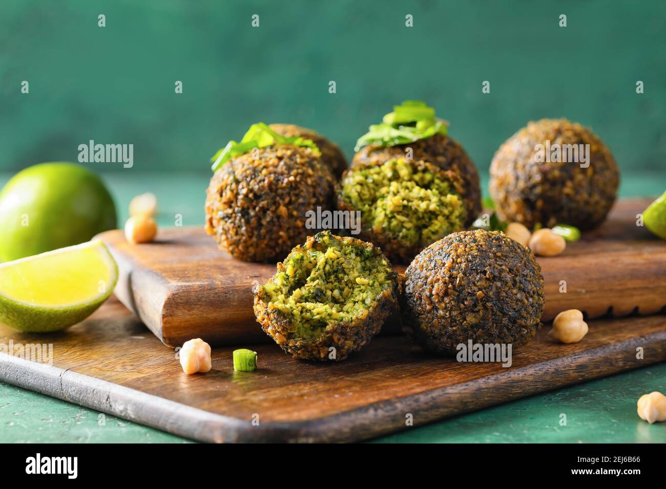 Board with tasty falafel balls and lime on color background Stock Photo ...