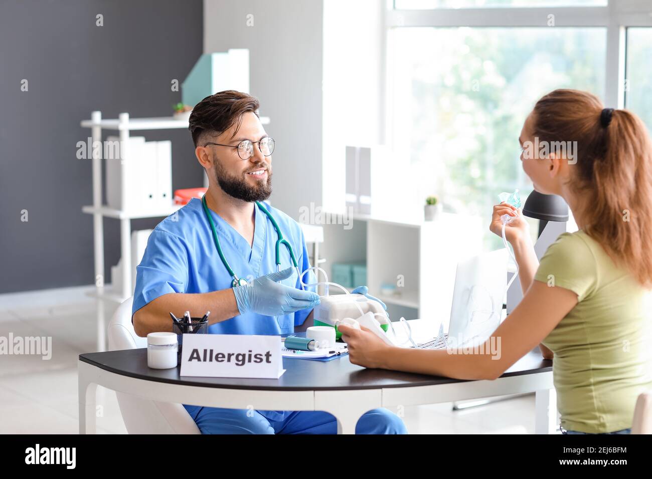 Young woman visiting allergist in clinic Stock Photo - Alamy