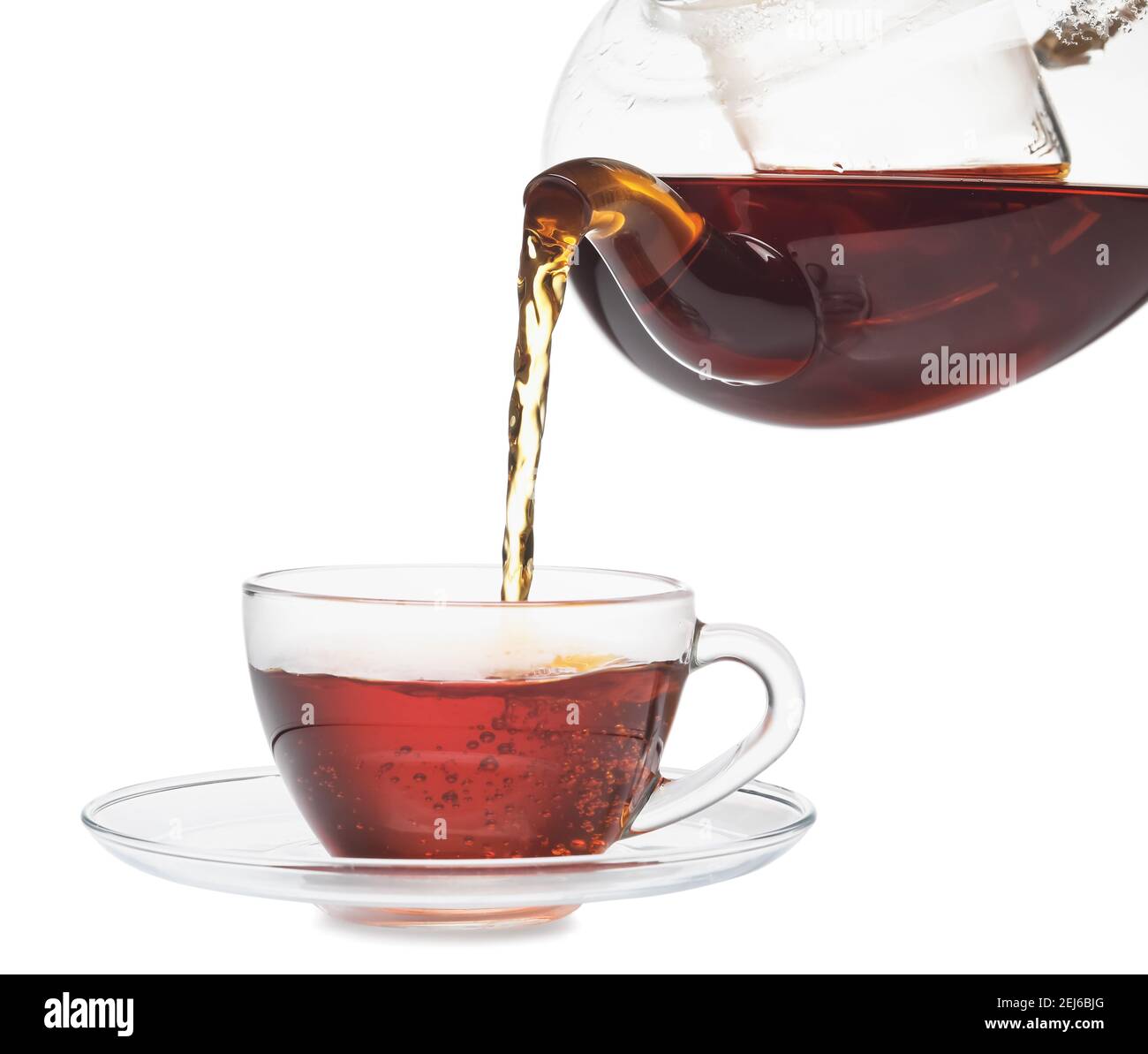 Pouring of hot tea from teapot into cup on white background Stock Photo ...