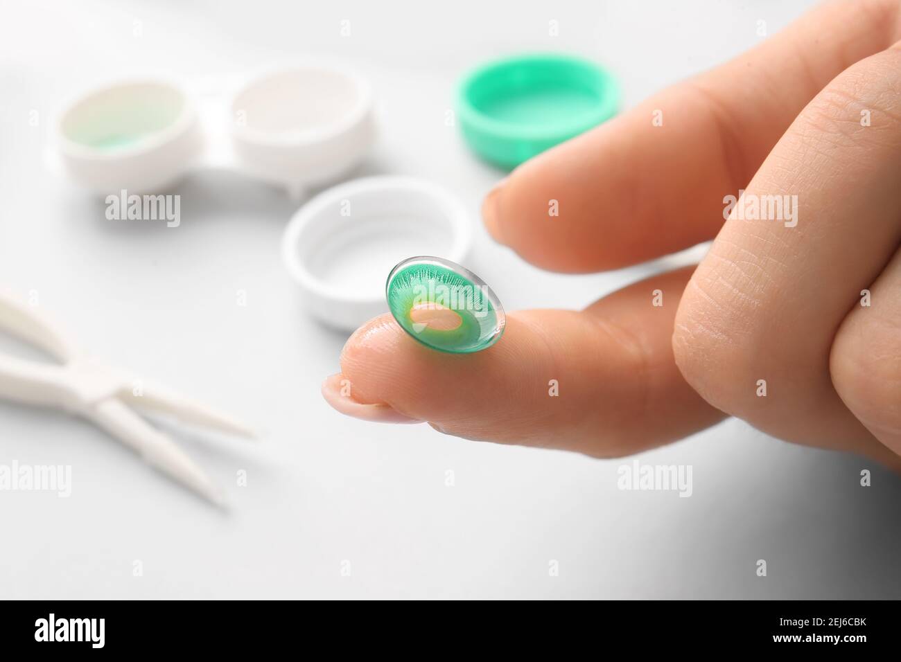 Female hand with contact lens on light background Stock Photo - Alamy