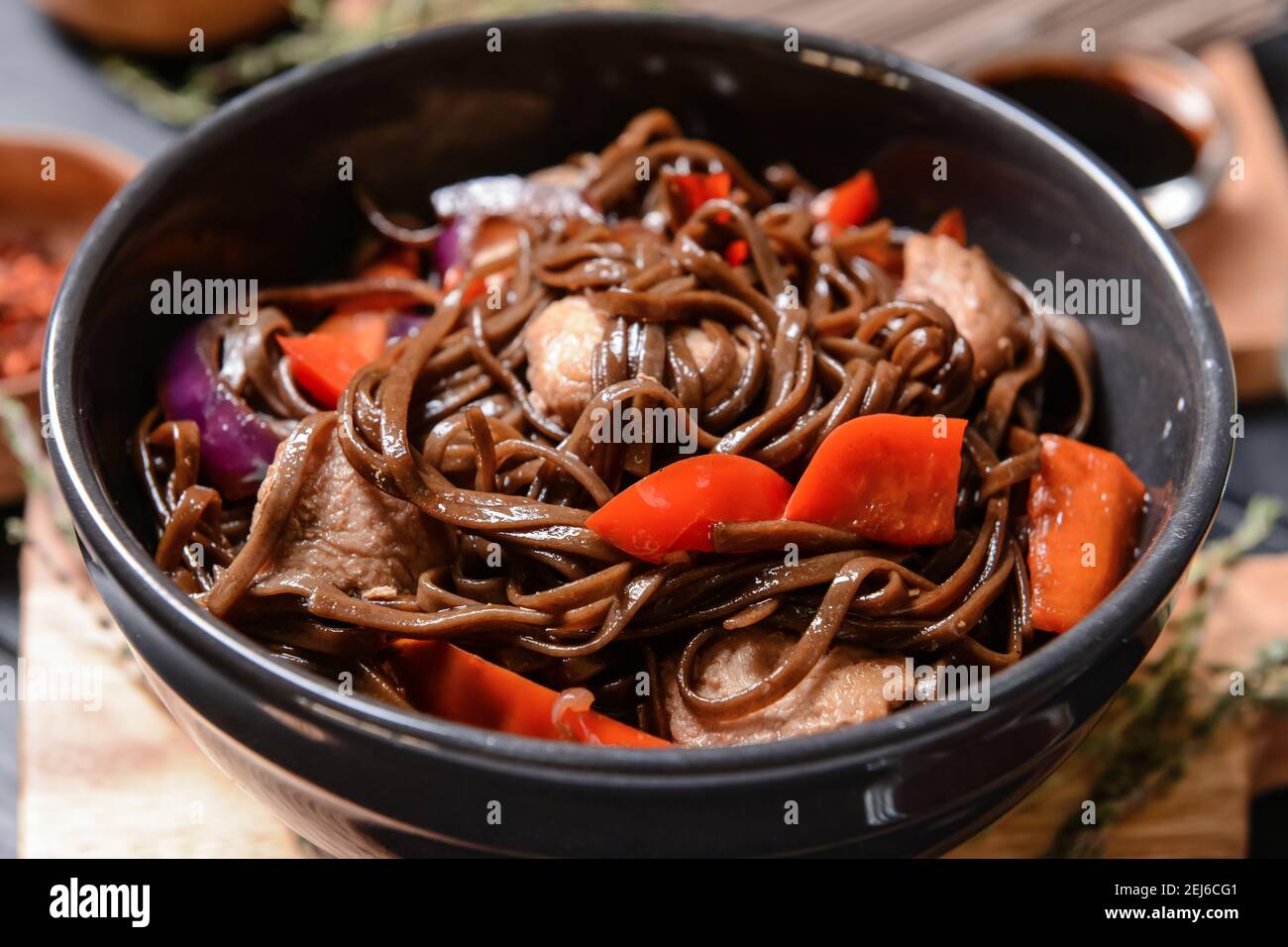 Plate with tasty soba noodles and meat on dark background Stock Photo ...