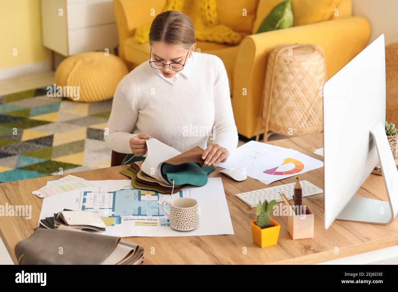 Female interior designer working in her office Stock Photo - Alamy