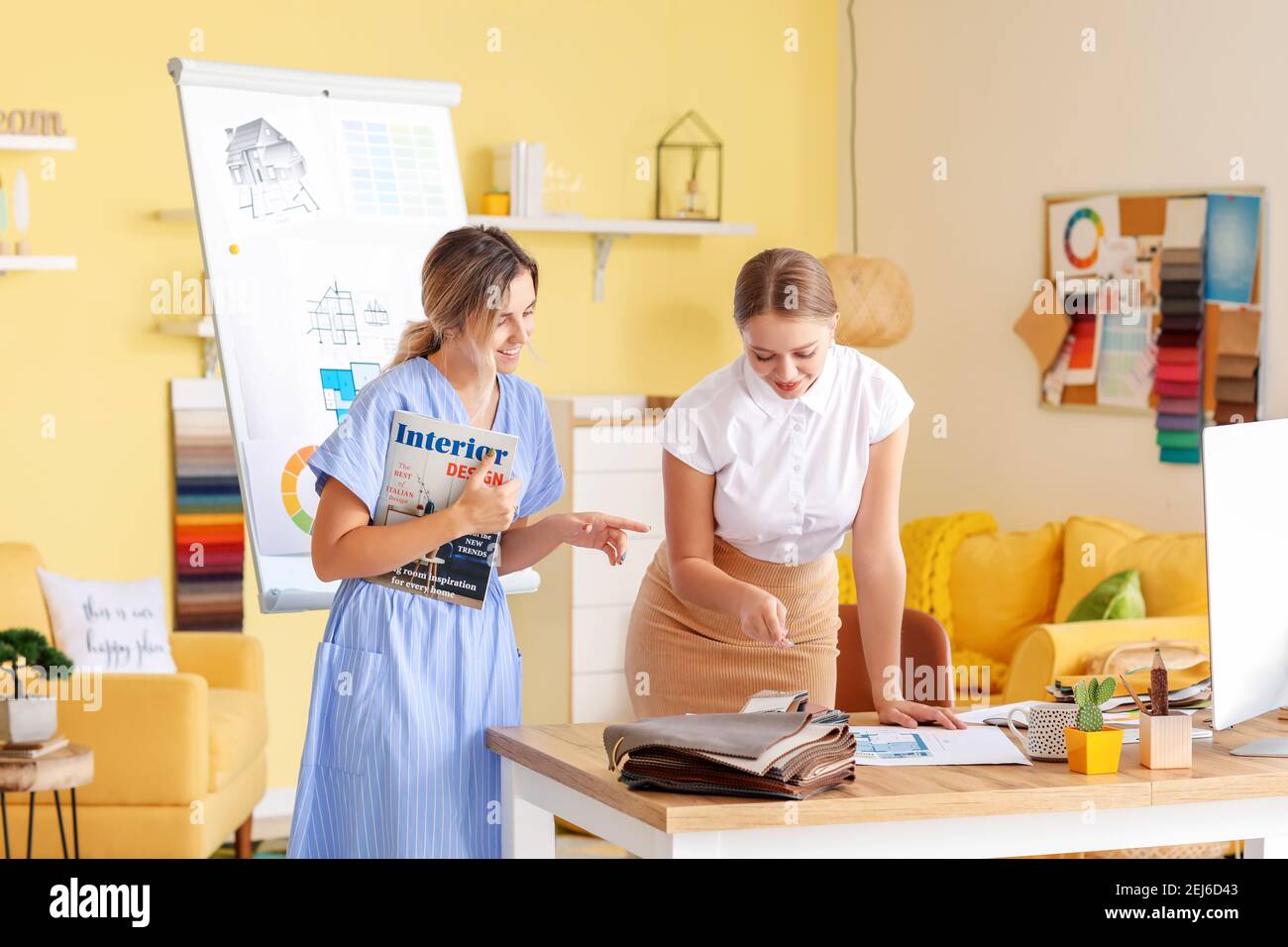 Female interior designer with client in her office Stock Photo - Alamy