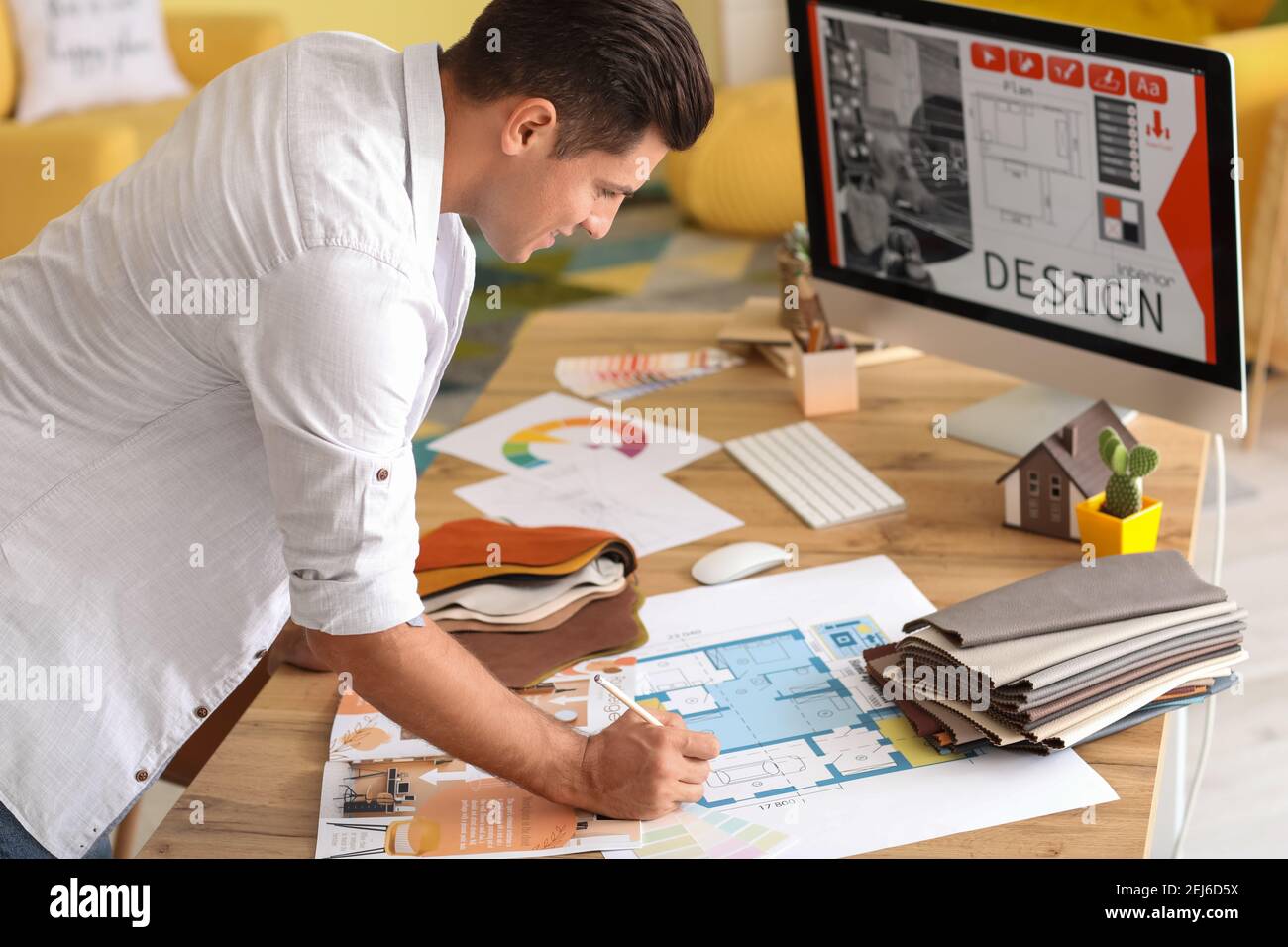 Male interior designer working in his office Stock Photo - Alamy