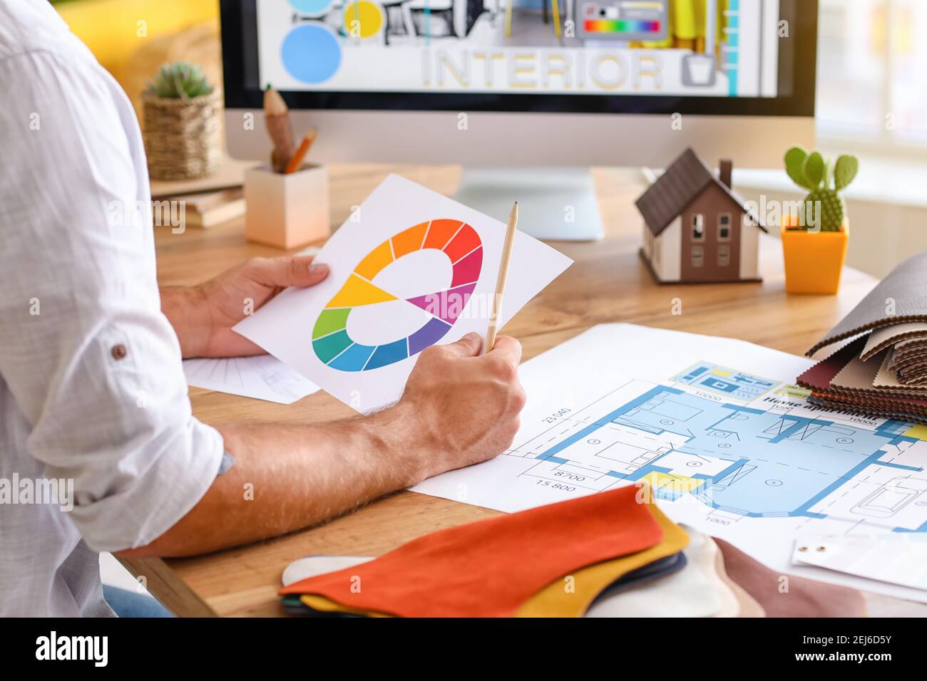 Male interior designer working in his office Stock Photo - Alamy