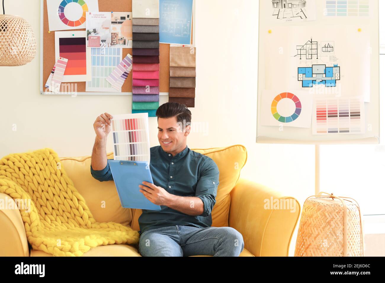 Male interior designer working in his office Stock Photo - Alamy