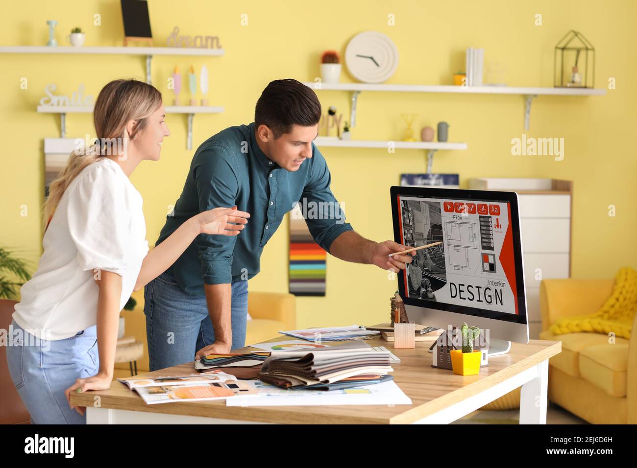 Male interior designer with client in his office Stock Photo - Alamy