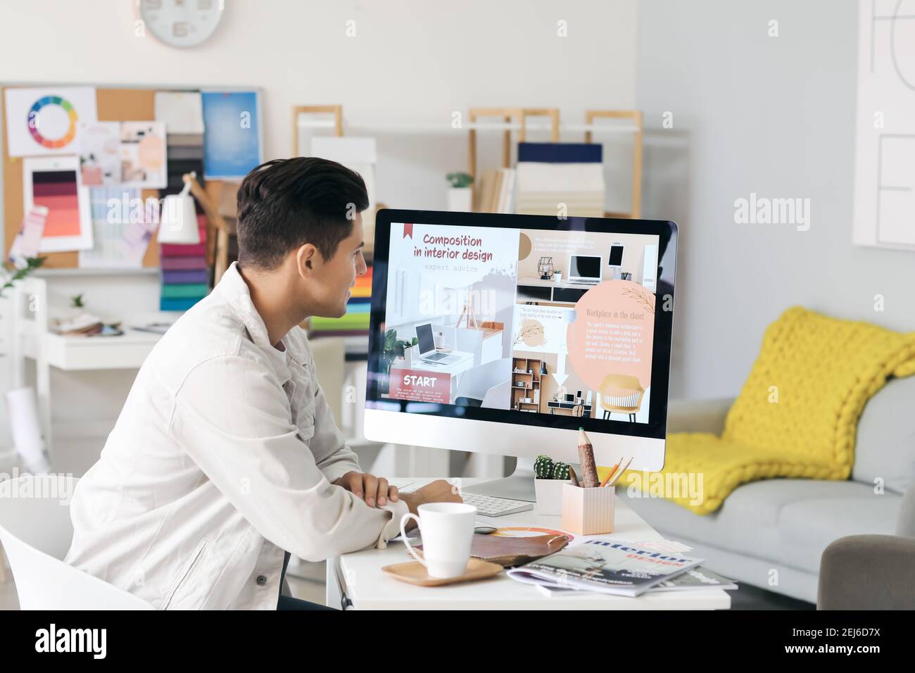 Male interior designer working in his office Stock Photo - Alamy