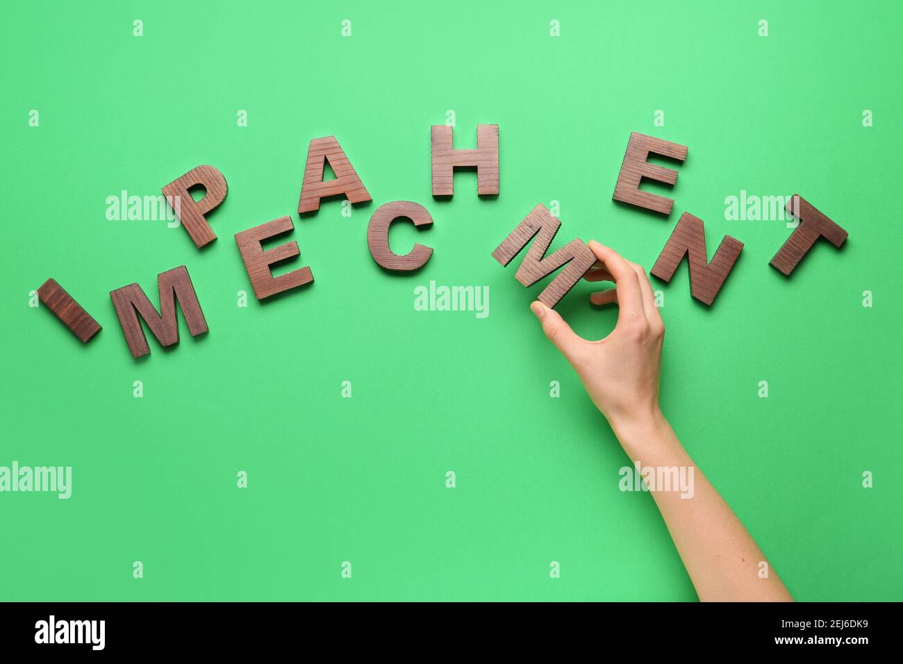 Hand composing word IMPEACHMENT of letters on color background Stock ...