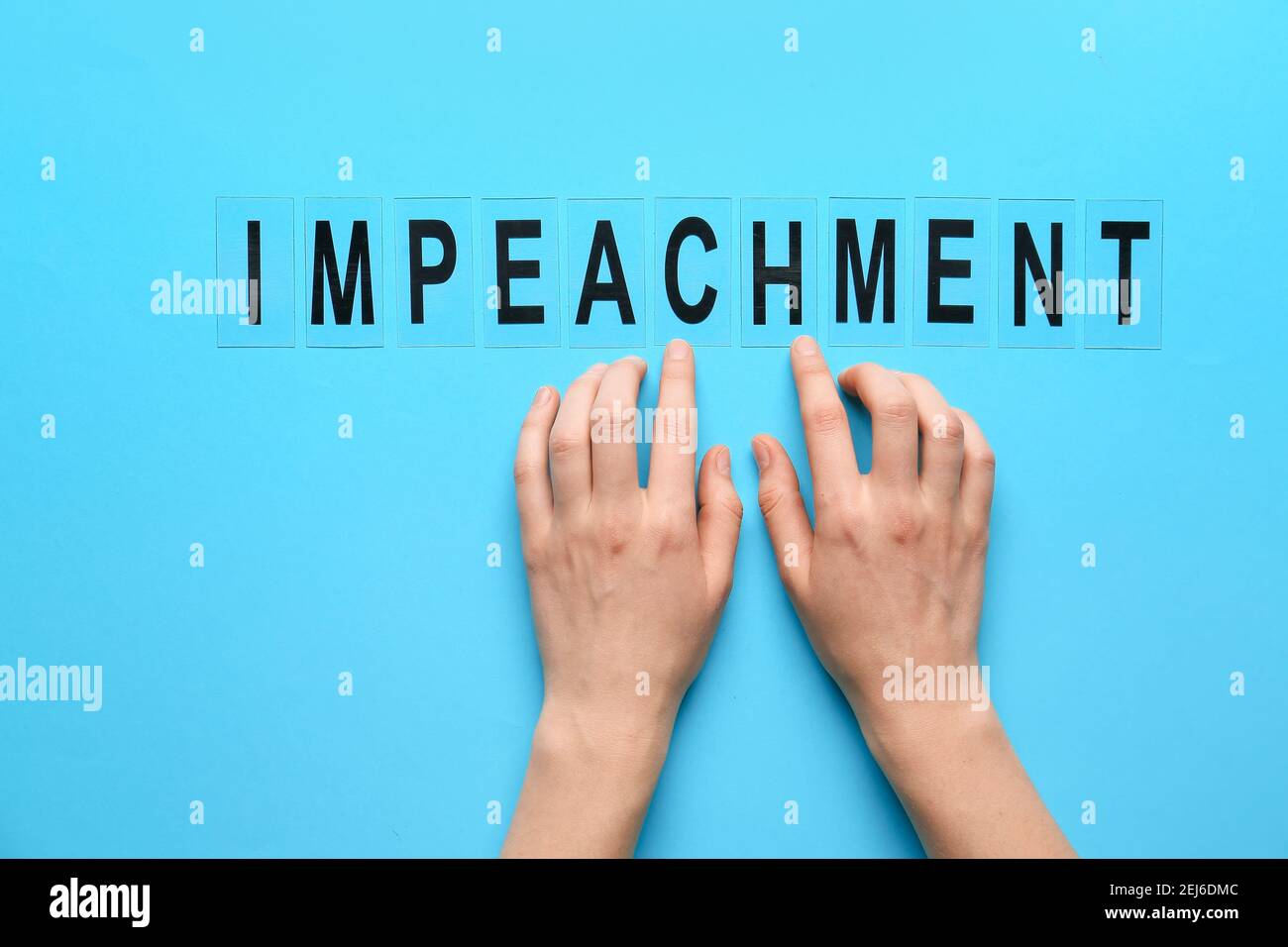 Hands and text IMPEACHMENT on color background Stock Photo - Alamy