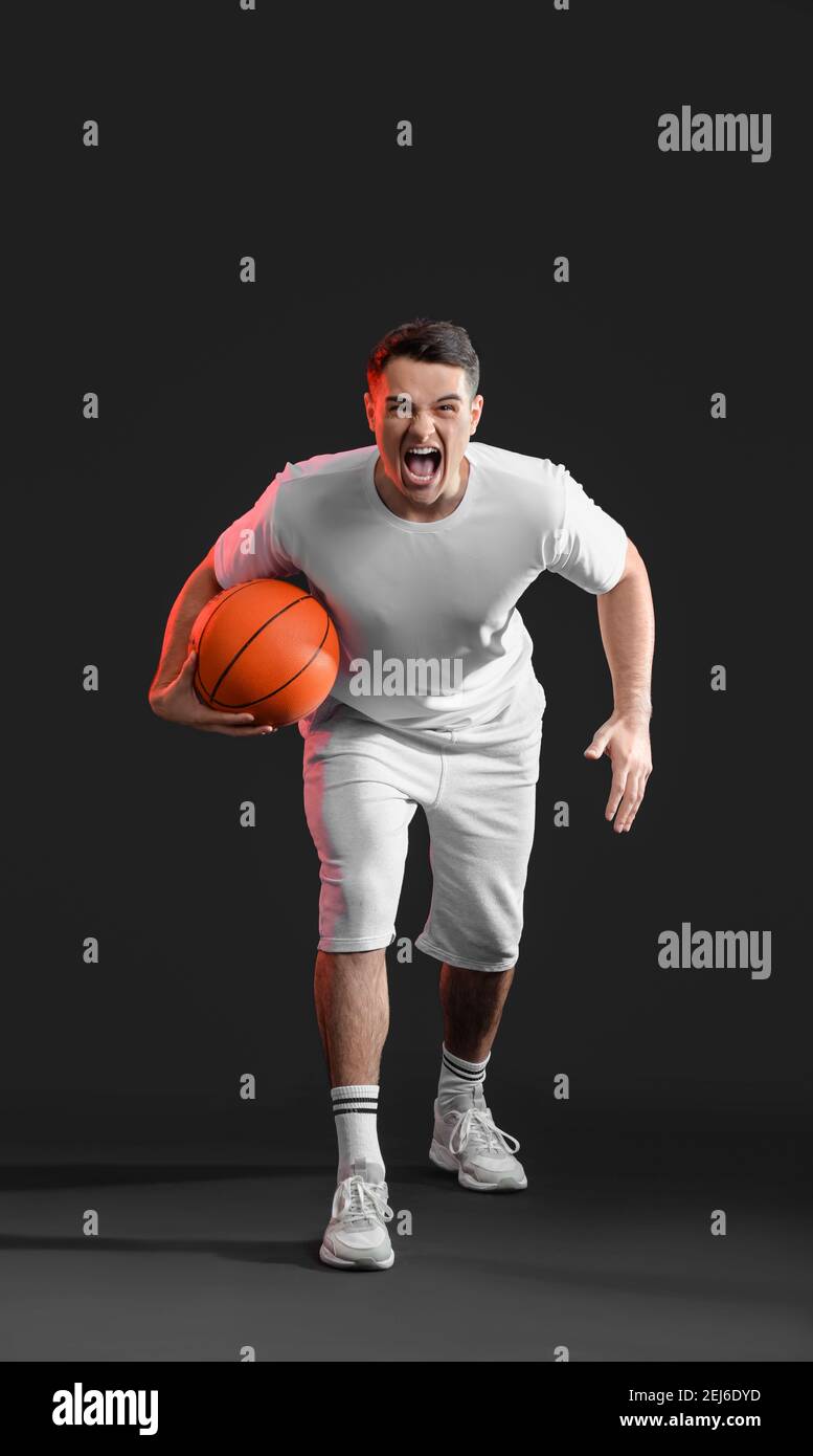 Aggressive basketball player on dark background Stock Photo - Alamy