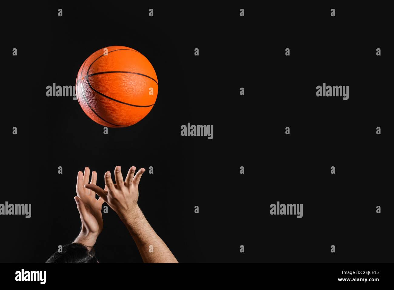 Male basketball player with ball on dark background Stock Photo - Alamy
