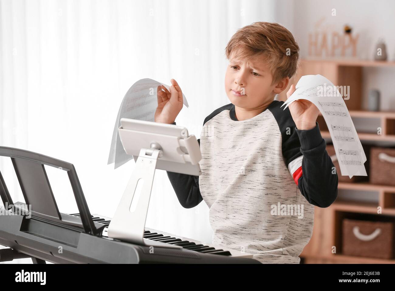 Little boy taking music lessons online at home Stock Photo - Alamy