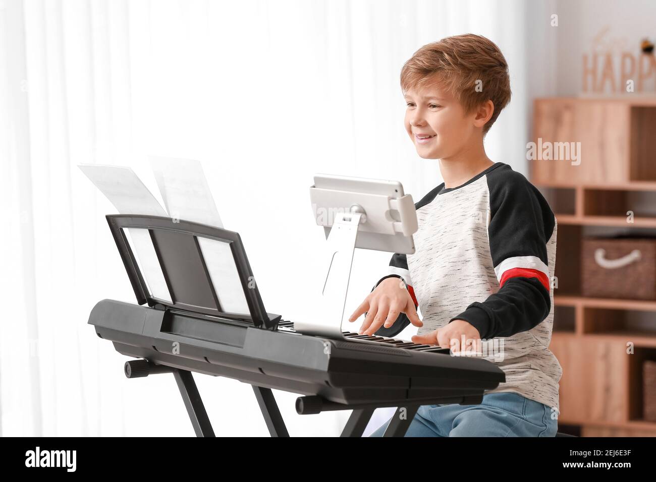 Little boy taking music lessons online at home Stock Photo - Alamy