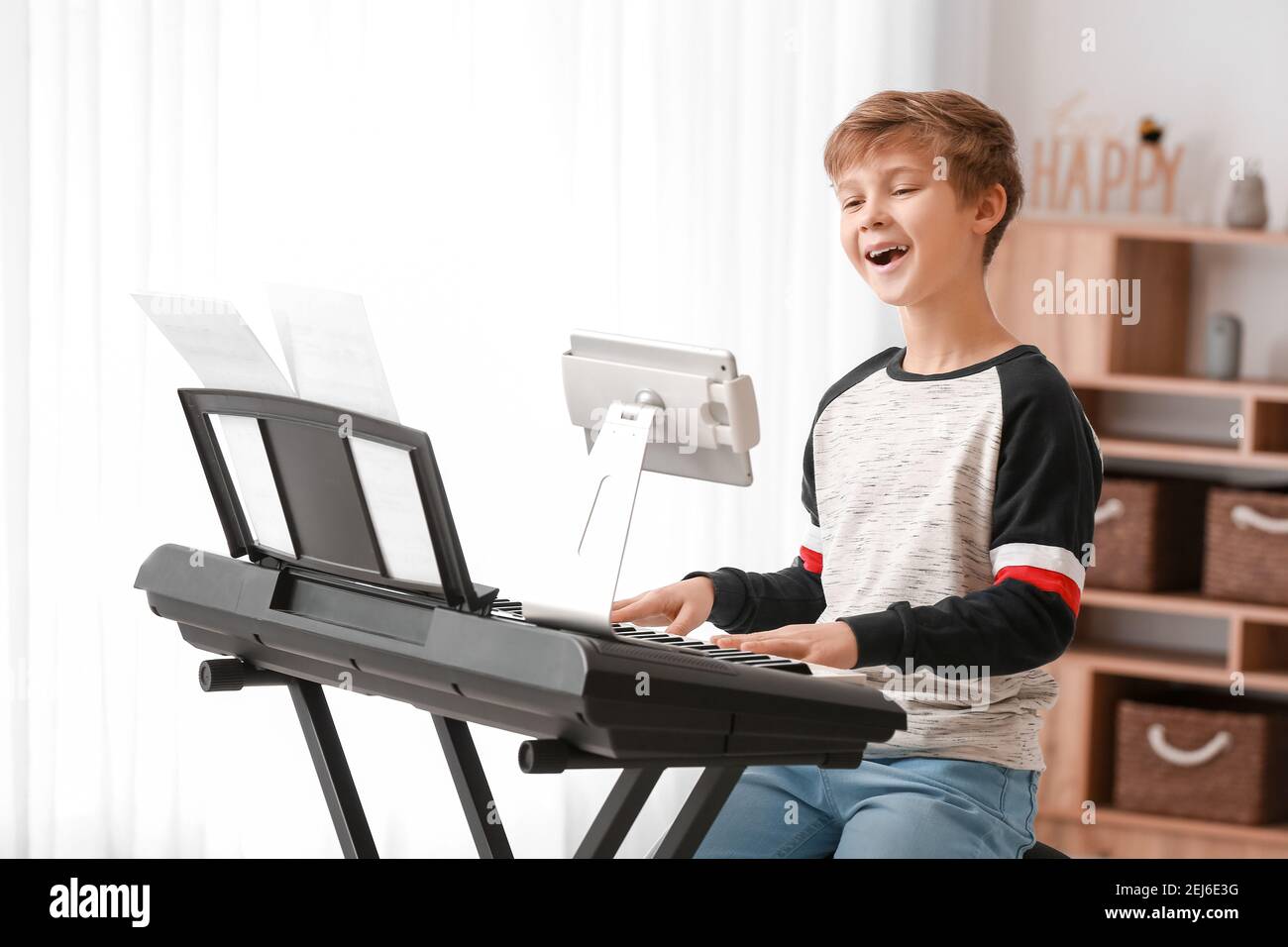 Little boy taking music lessons online at home Stock Photo - Alamy