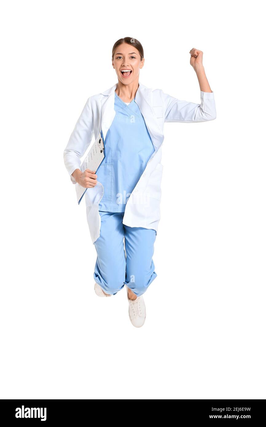 Jumping female doctor against white background Stock Photo - Alamy