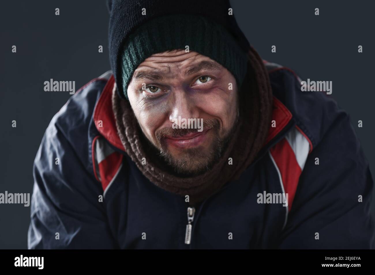 Portrait of poor homeless man on dark background Stock Photo - Alamy