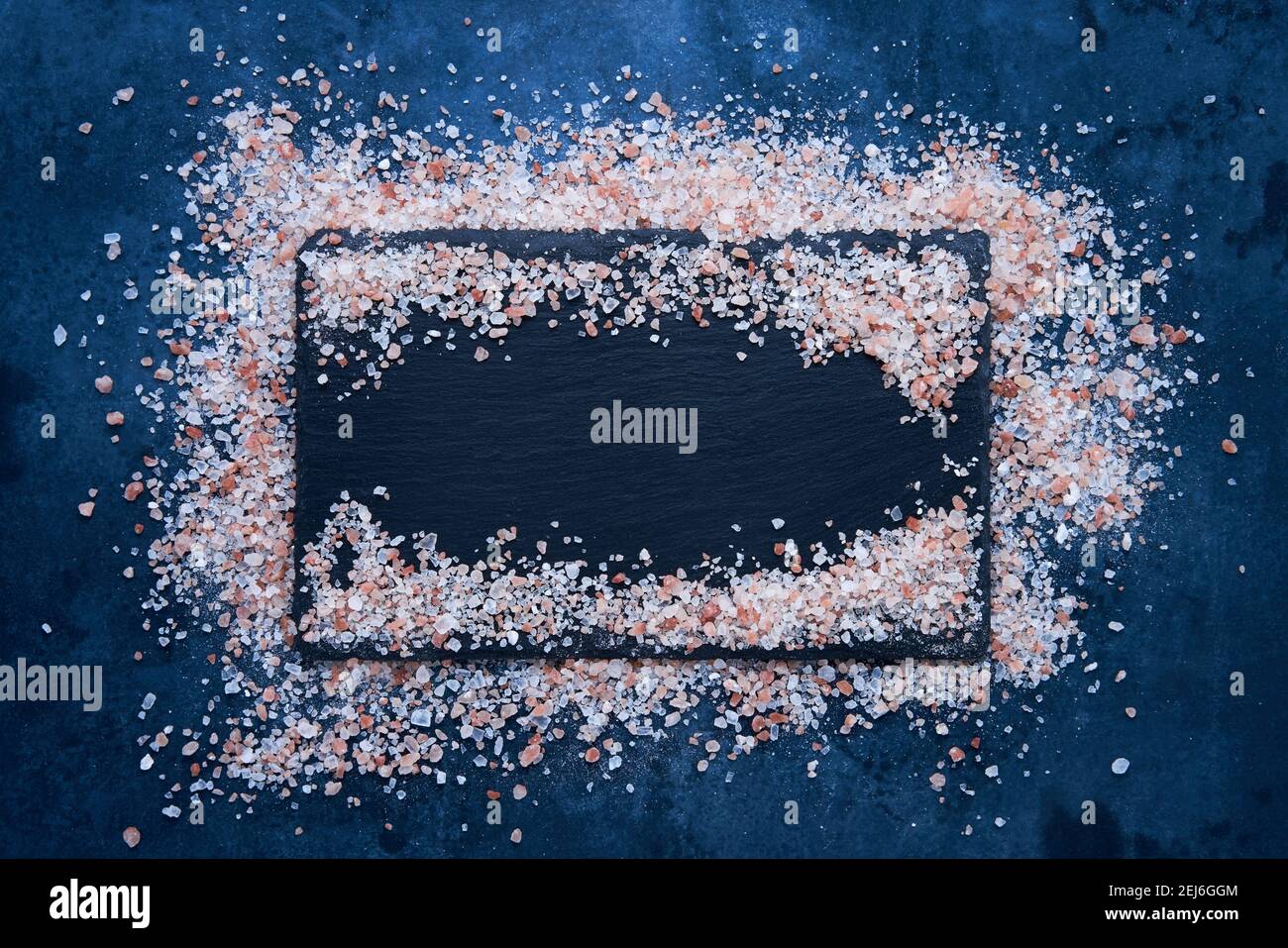 Himalayan rock salt on a slate board on dark blue background. Food ...