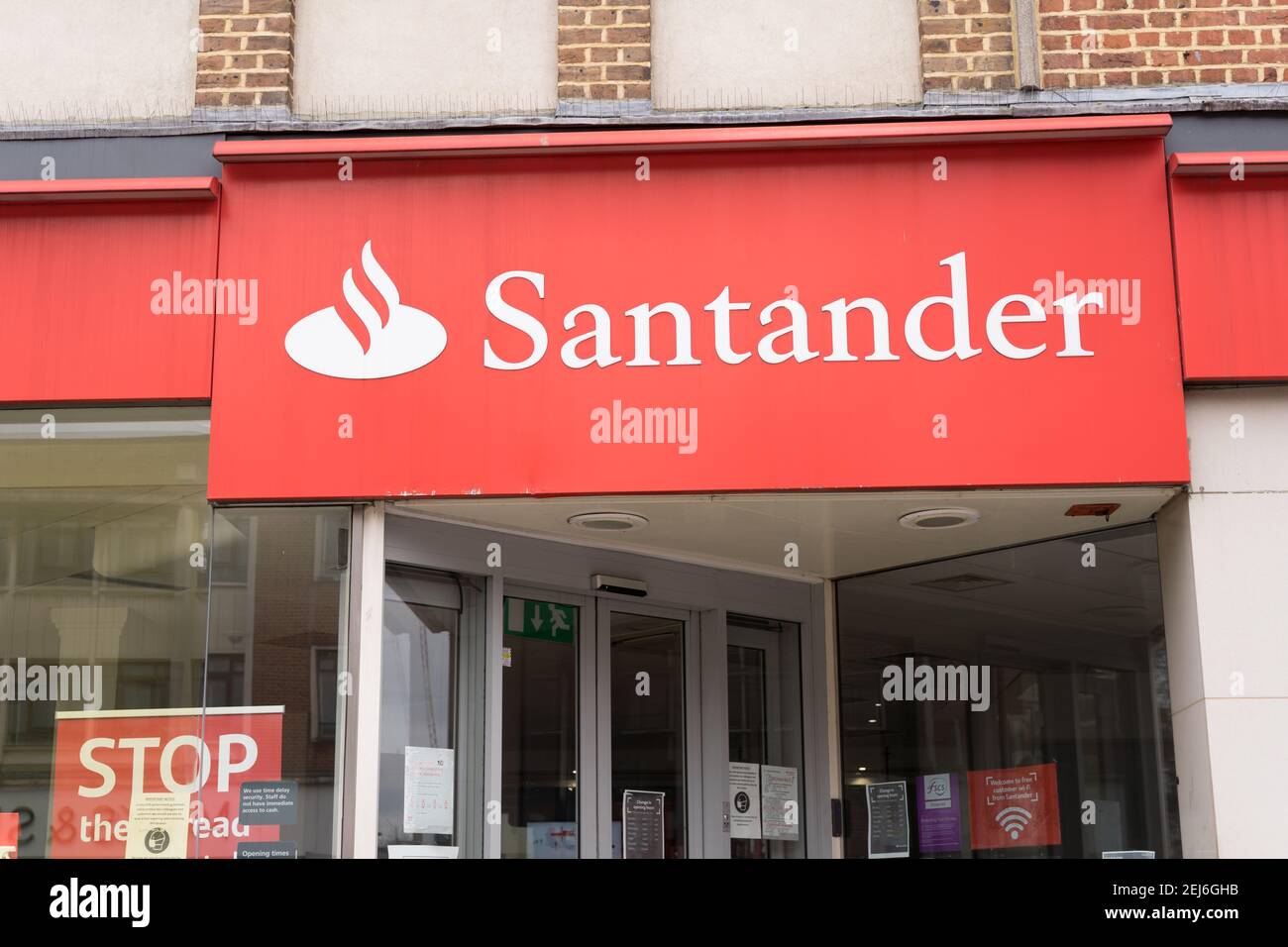 Santander brand logo on top of entrance to branch on high street Stock ...