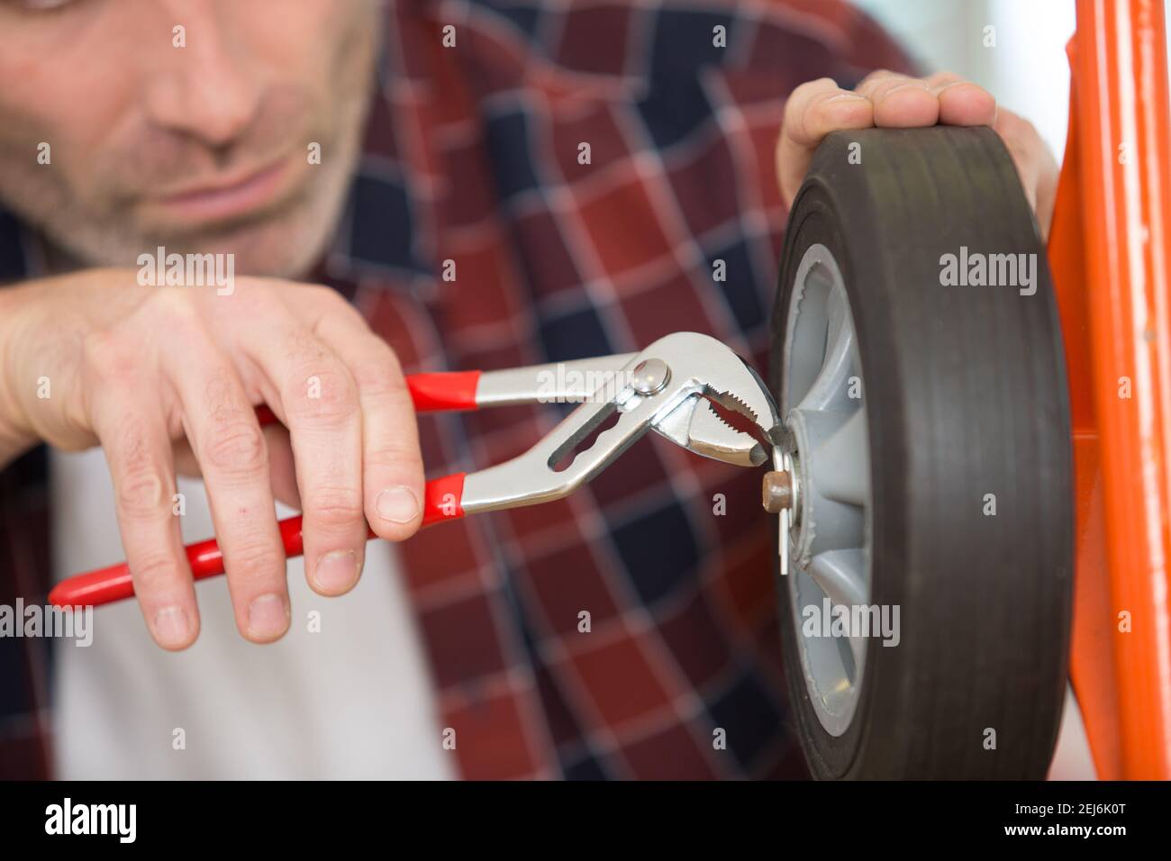 man using pliers to place a split pin Stock Photo - Alamy