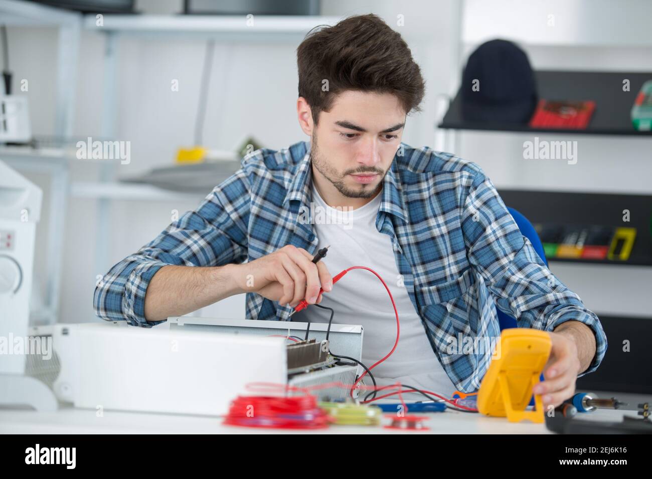 men and measurement of voltage Stock Photo - Alamy