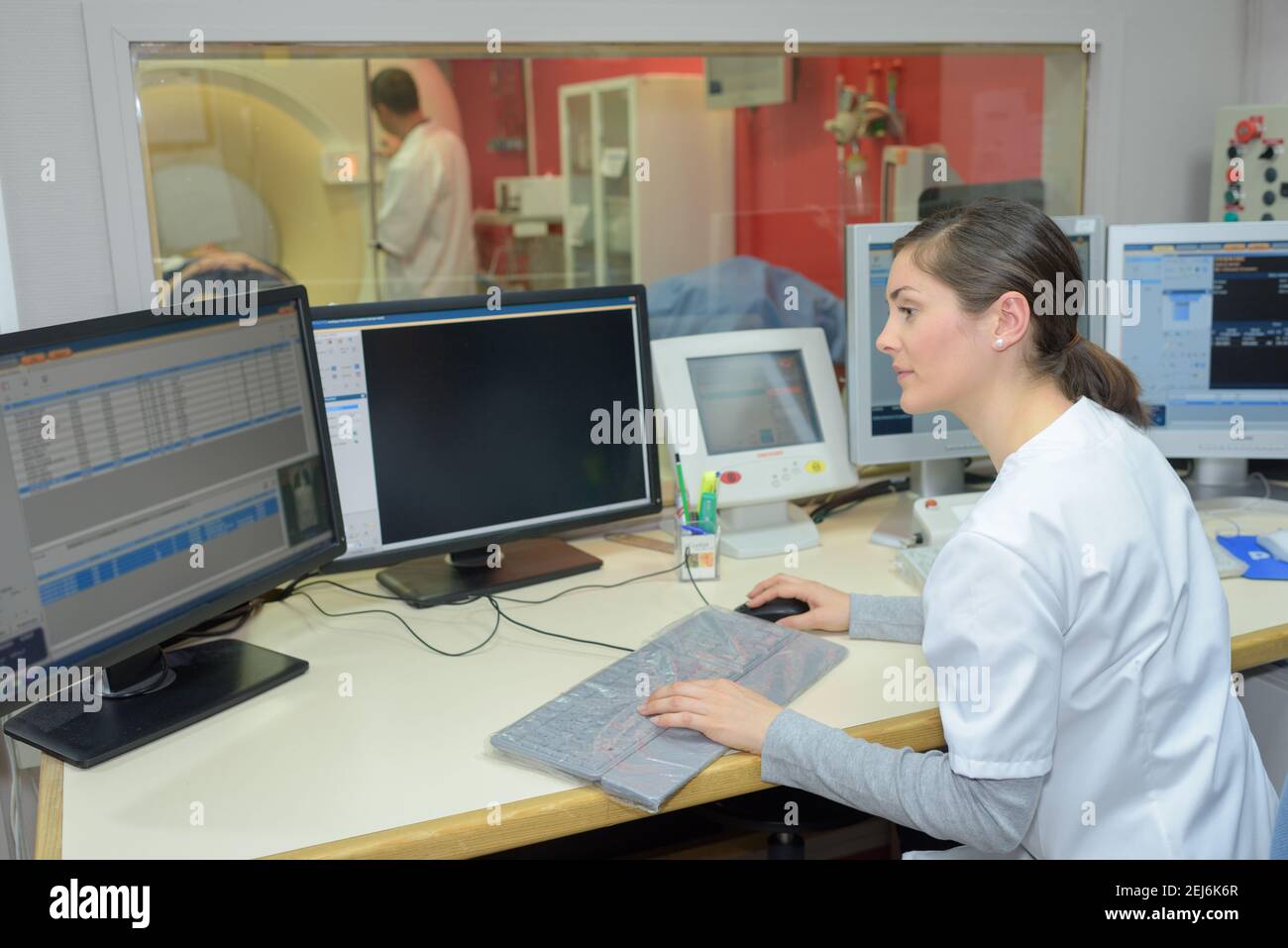mri machine and screens with doctor and nurse Stock Photo - Alamy