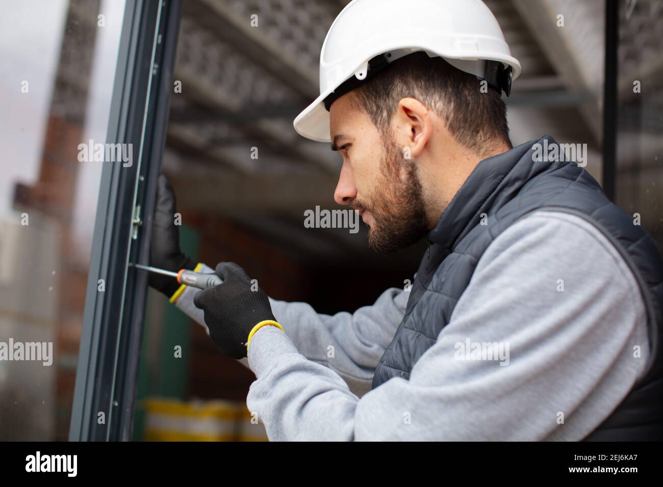 handsome young man installing bay window Stock Photo - Alamy