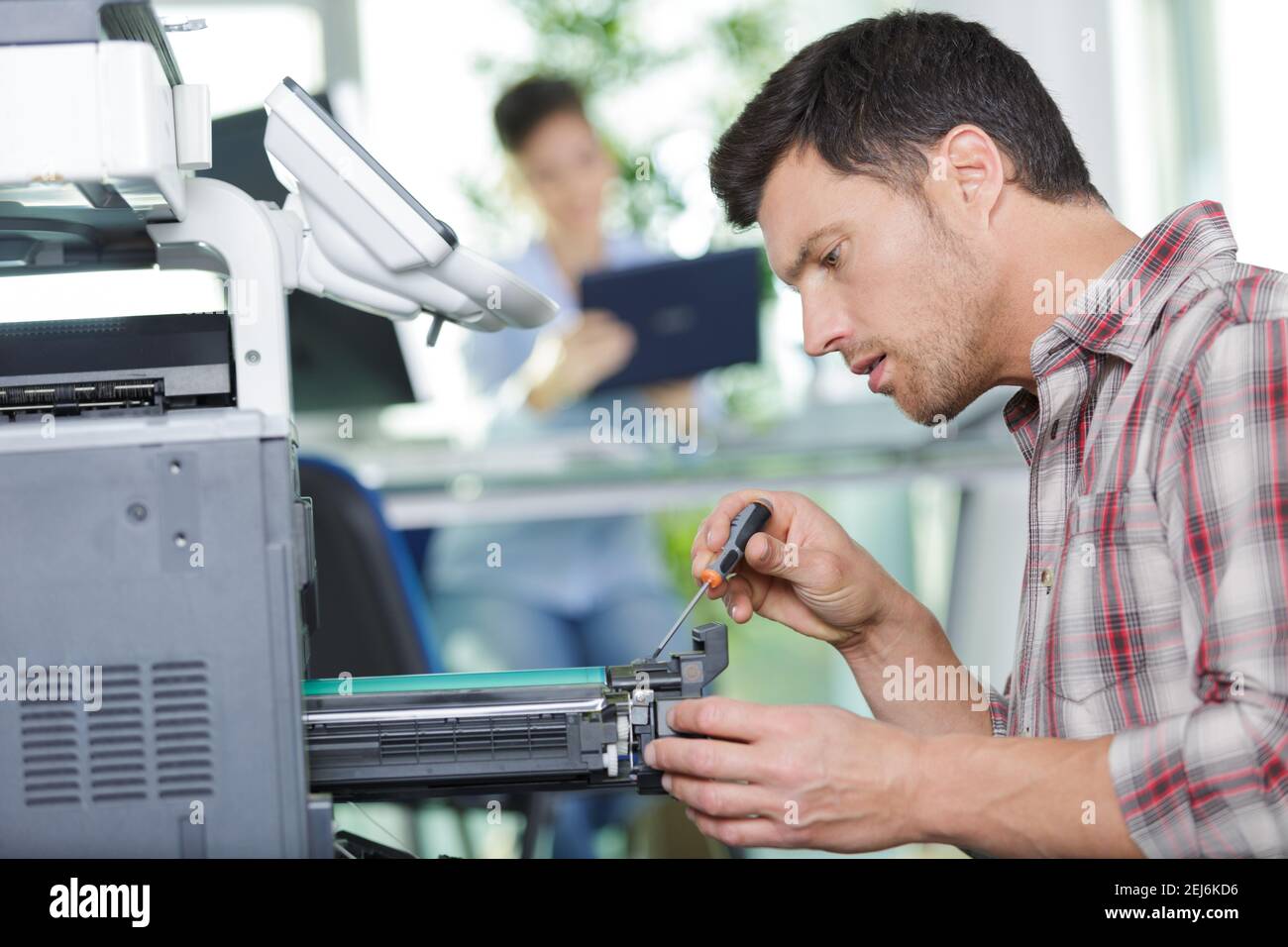 a technician is fixing a printer machine Stock Photo - Alamy