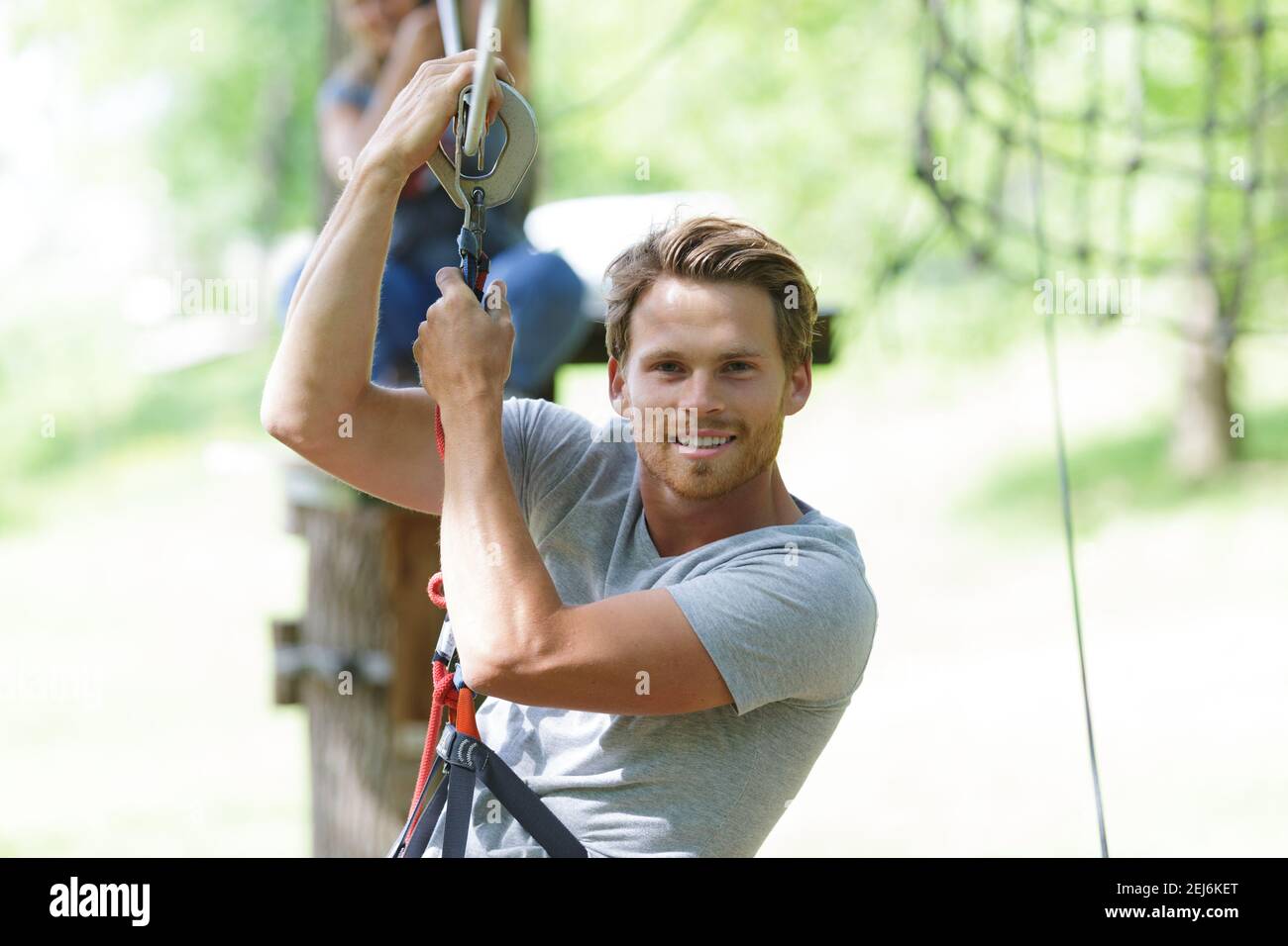 Young man on zipline hi-res stock photography and images - Alamy
