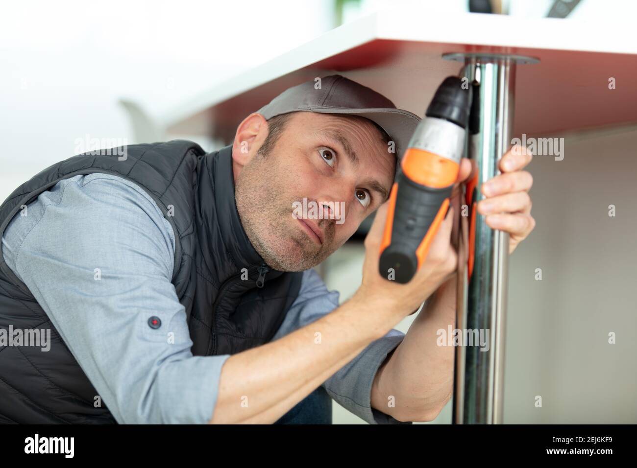man using hand drill to build new furniture Stock Photo - Alamy