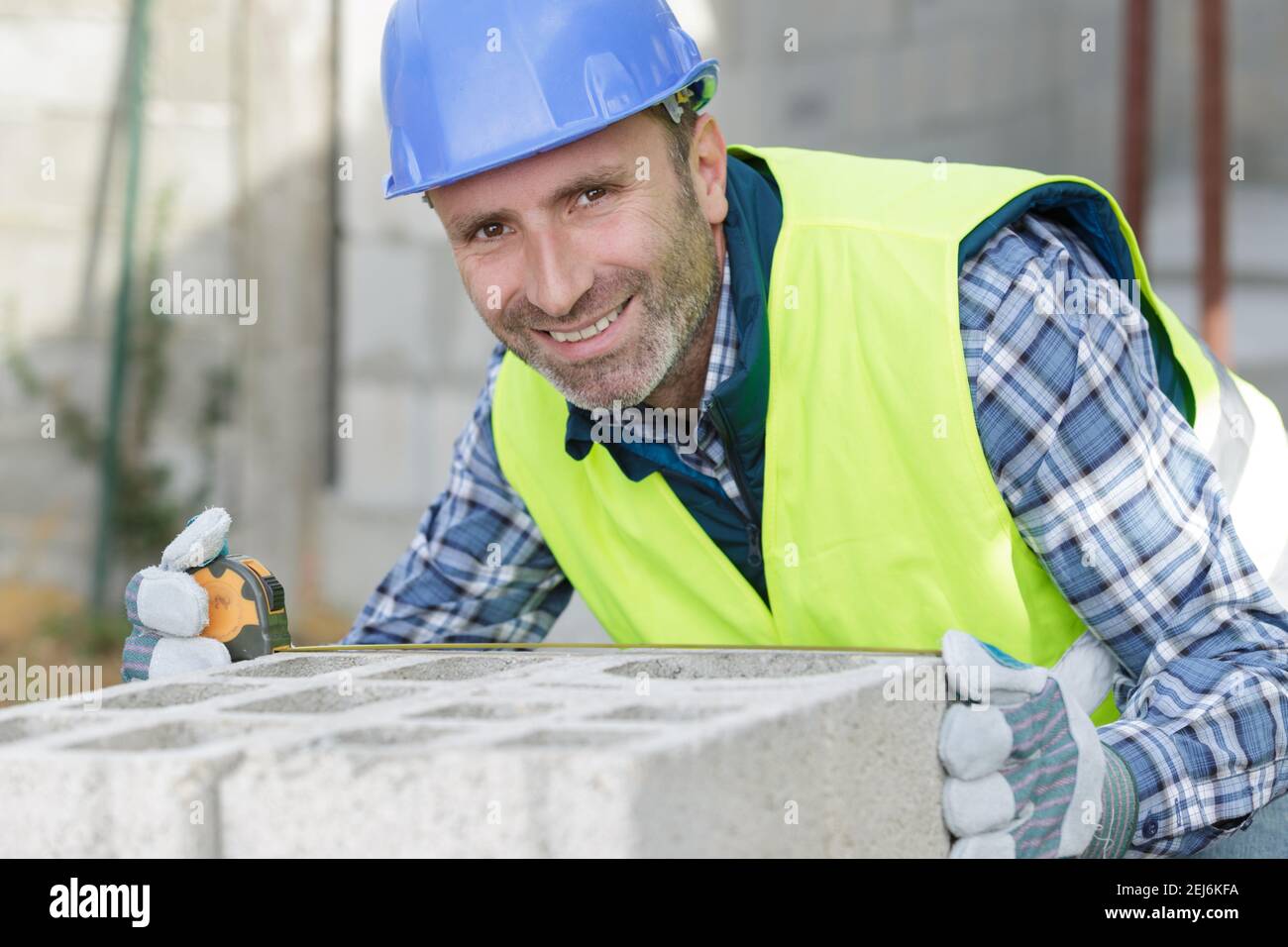 a happy man builder outdoors Stock Photo - Alamy