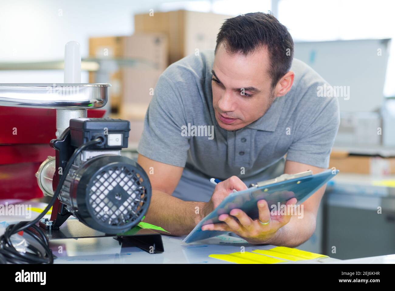 young engineer taking notes at control room in factory Stock Photo - Alamy