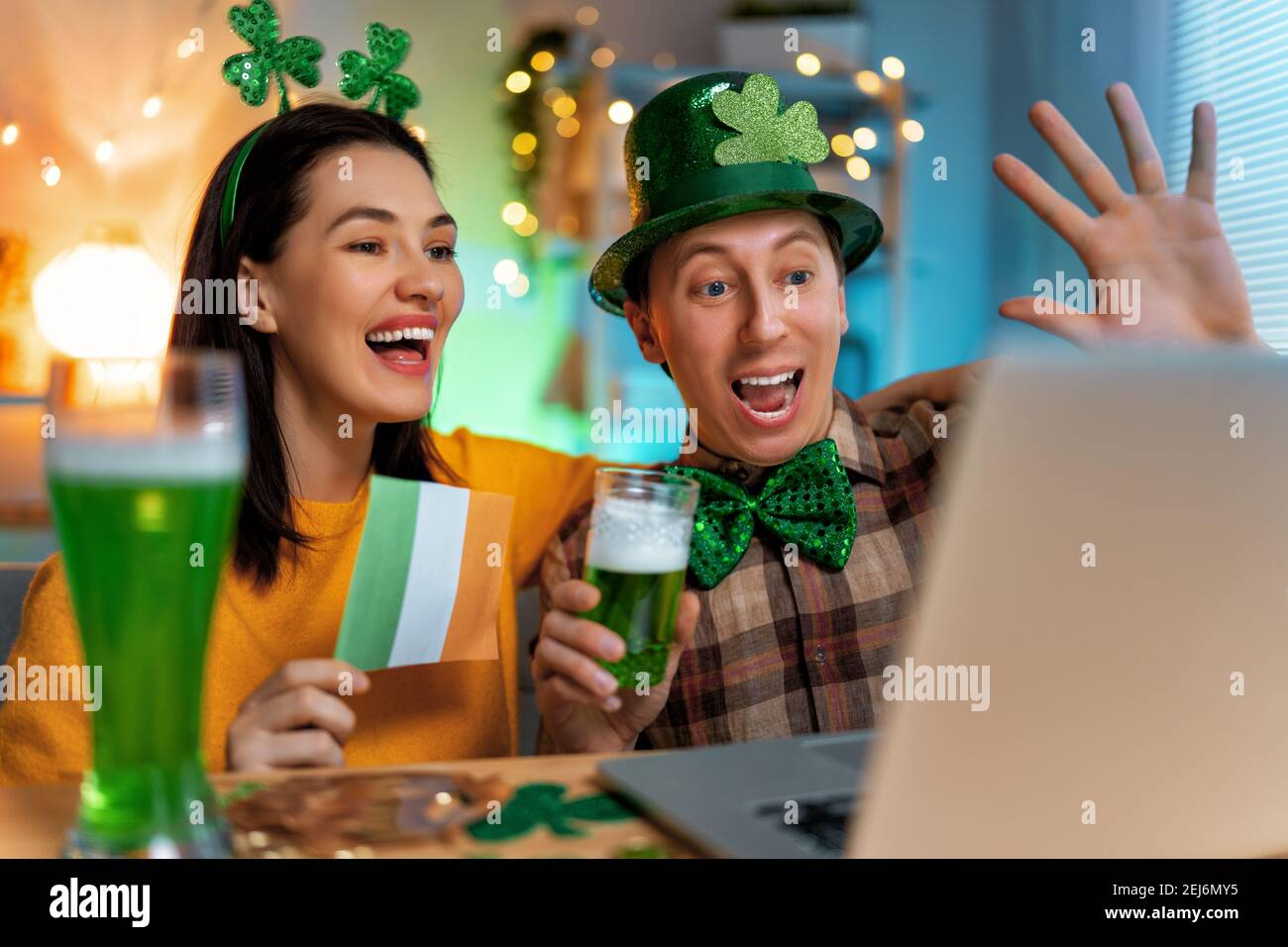 Happy family couple celebrating St. Patrick's Day with their friends by ...