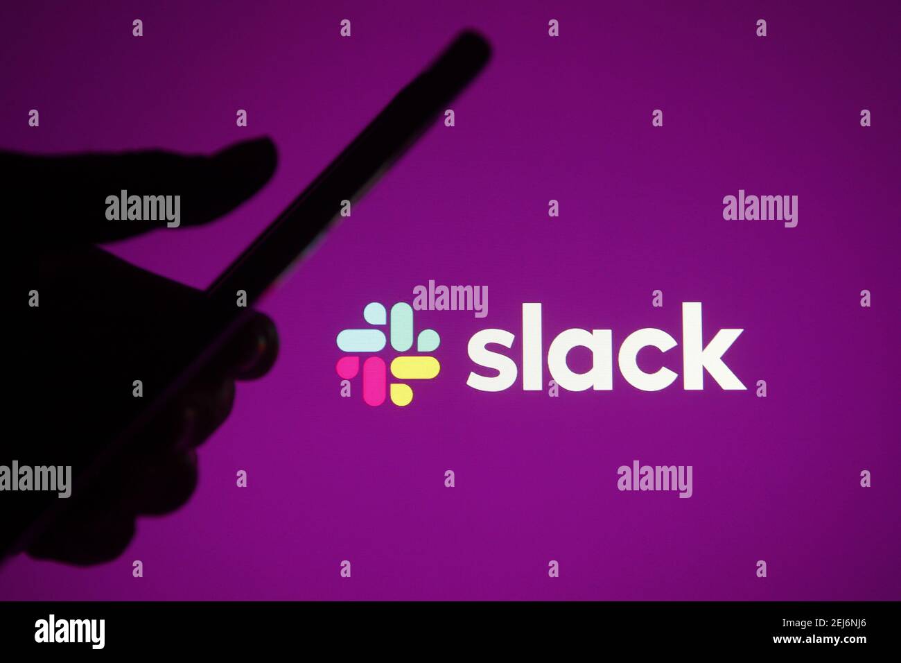 In this photo illustration a silhouette hand holding a smartphone is ...