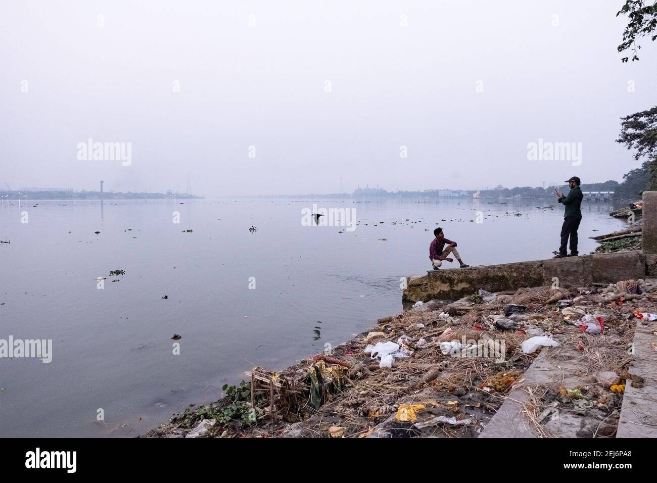 Men take photos at the polluted banks of river Ganga. Water pollution ...