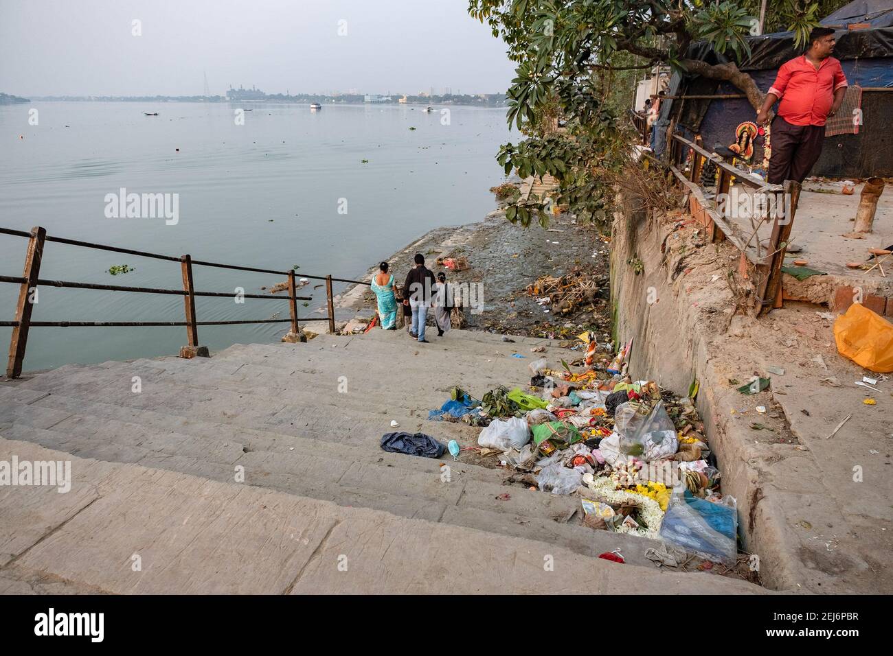 People seen at the polluted banks of river Ganga. Water pollution is ...