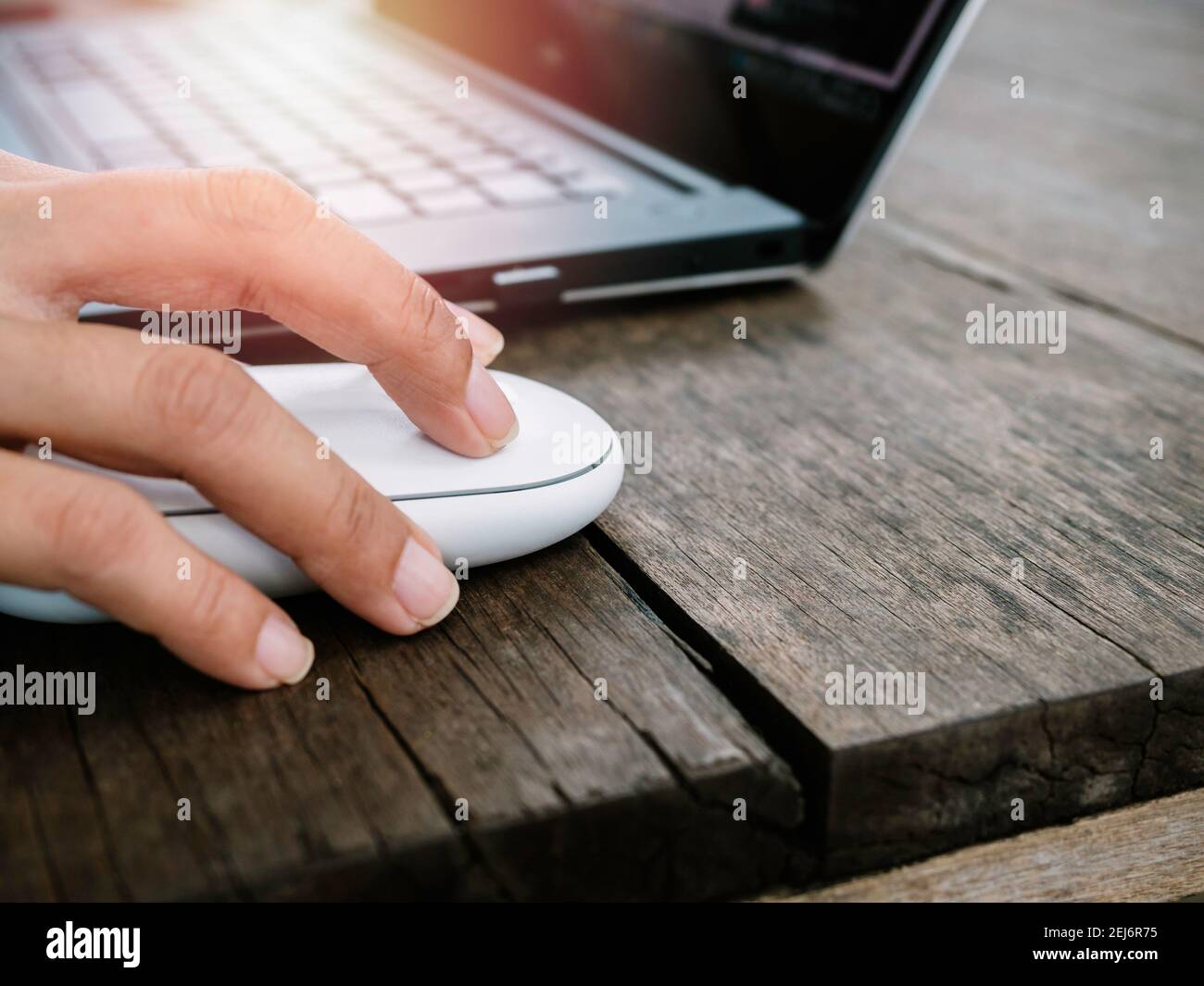 Close up finger using modern white wireless mouse while working on ...
